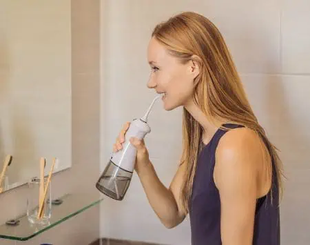 5 Benefits of Water Flossing: Why You Should and the Pros and Cons